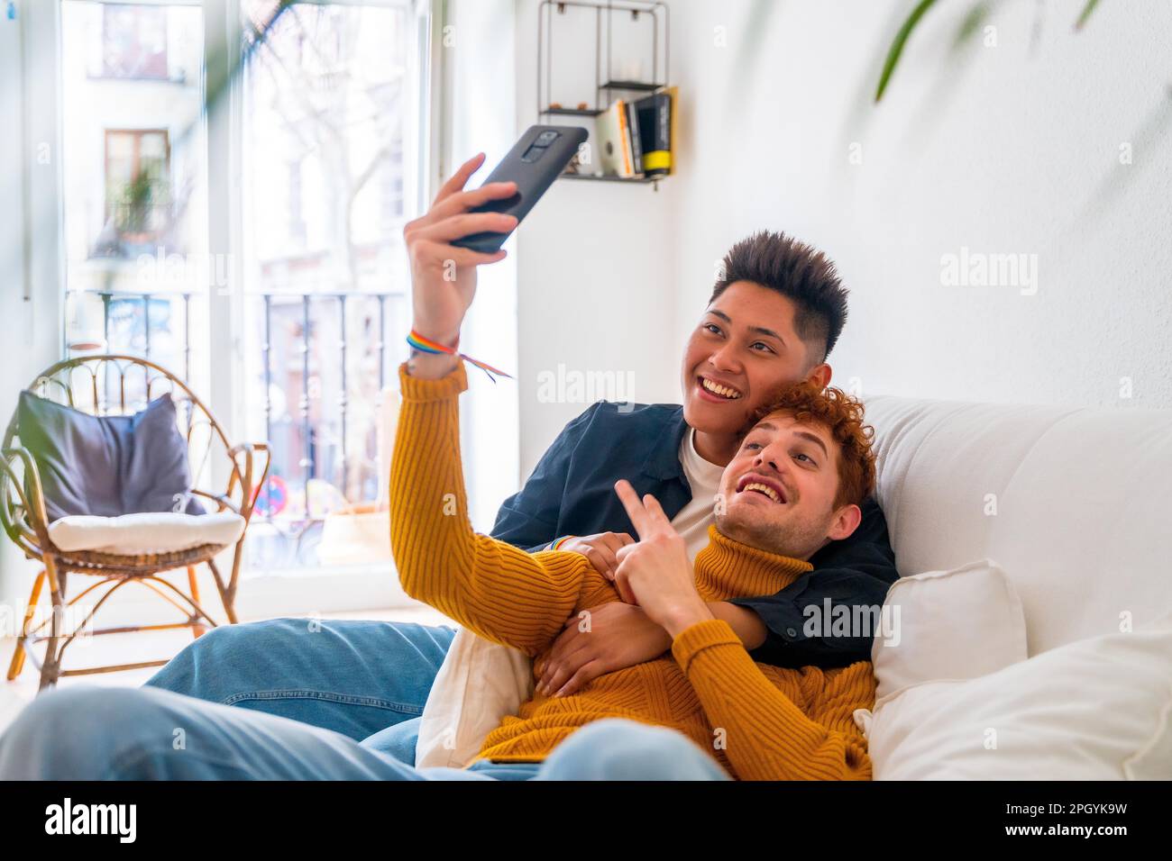 Beautiful Gay Couple Being Romantic At Home On The Sofa On A Video