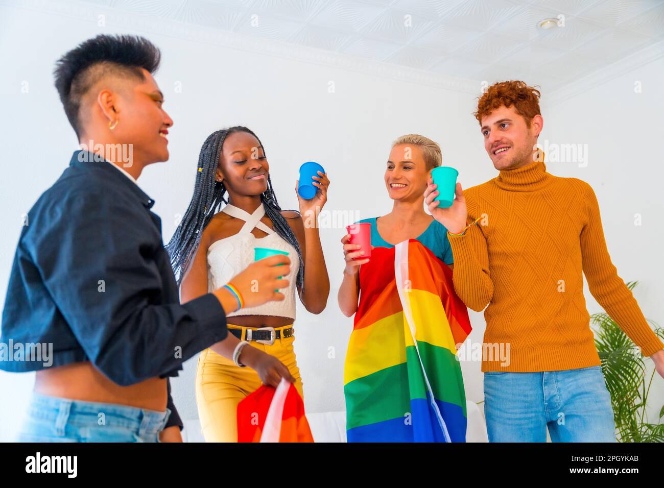 LGBT pride, lgbt rainbow flag, group of friends dancing and toasting ...