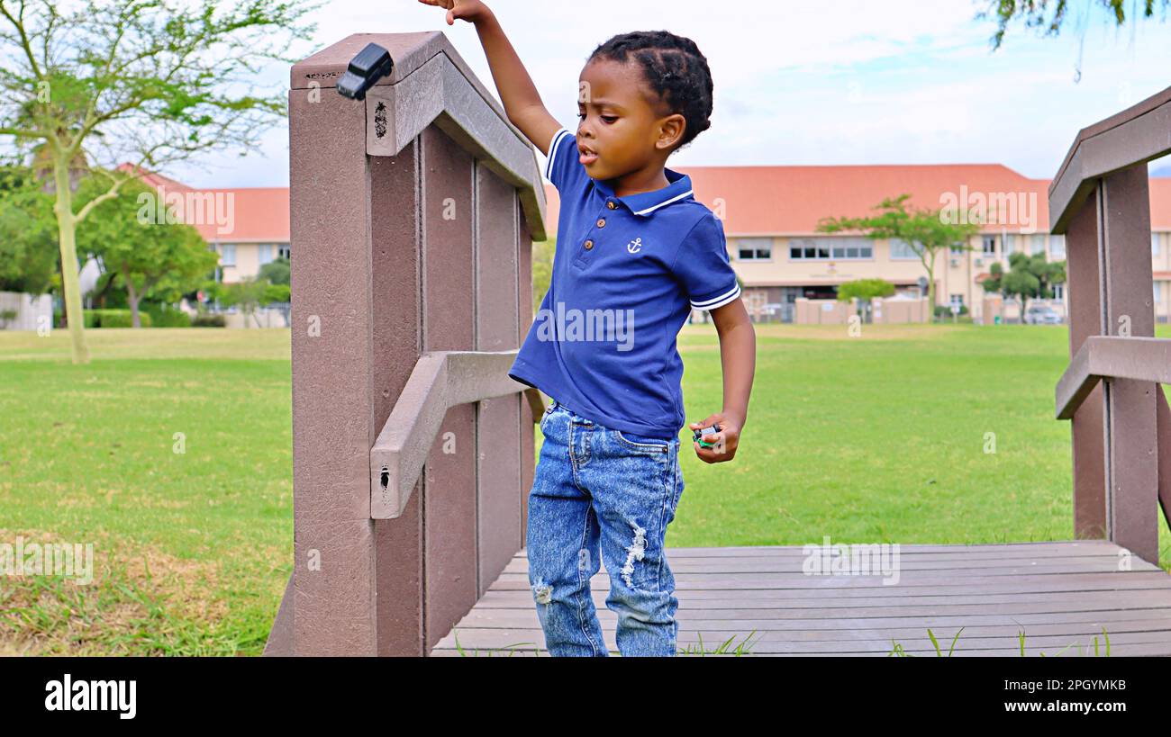 black African boy child playing in a park Stock Photo - Alamy