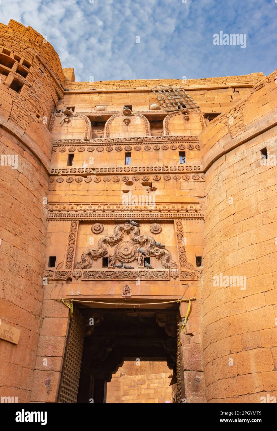vintage heritage fort entrance gate with bright sky from flat angle is ...