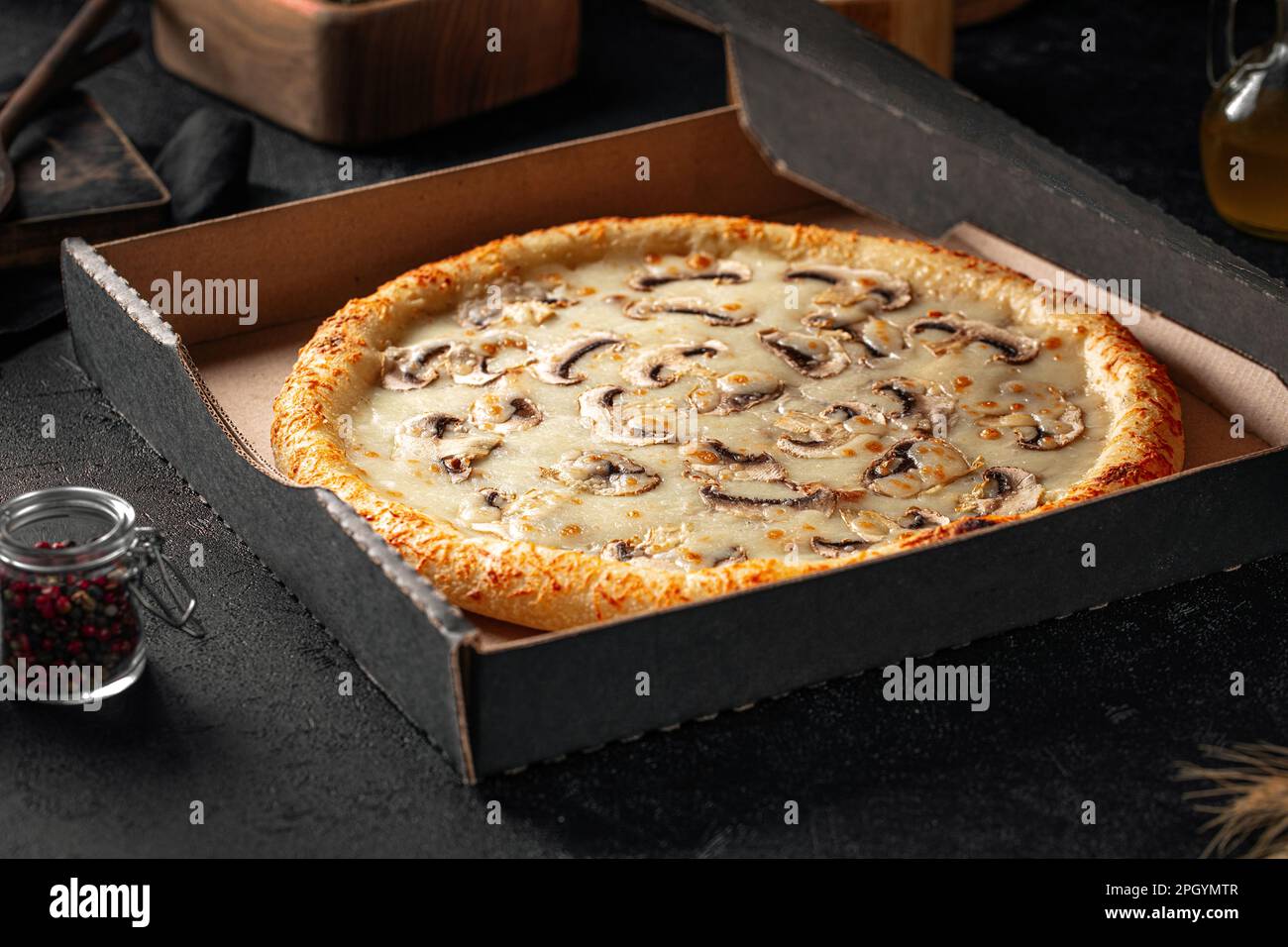 Take away backed mushroom pizza with cheese Stock Photo - Alamy