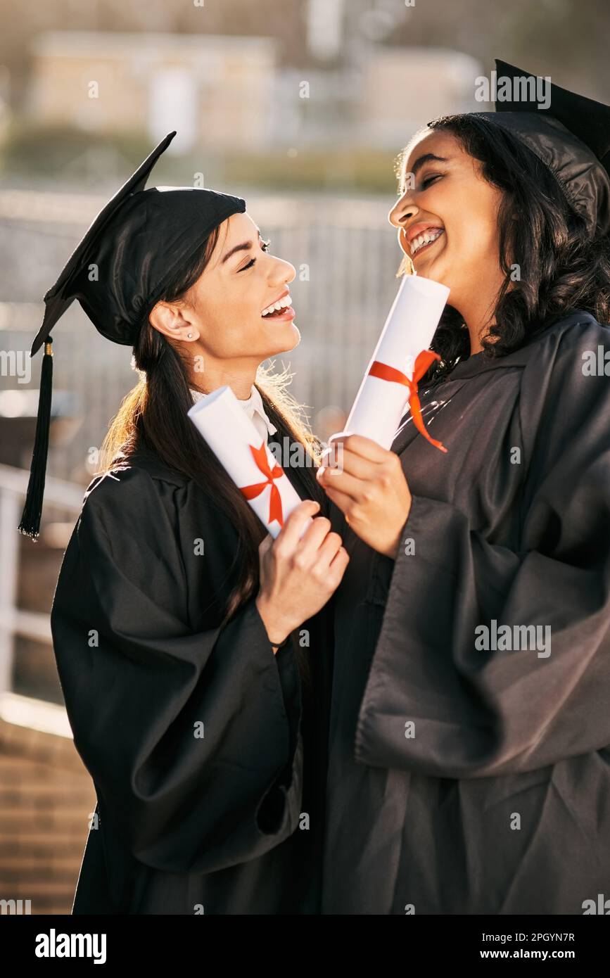 Well done to us. two students holding their diplomas on graduation day ...