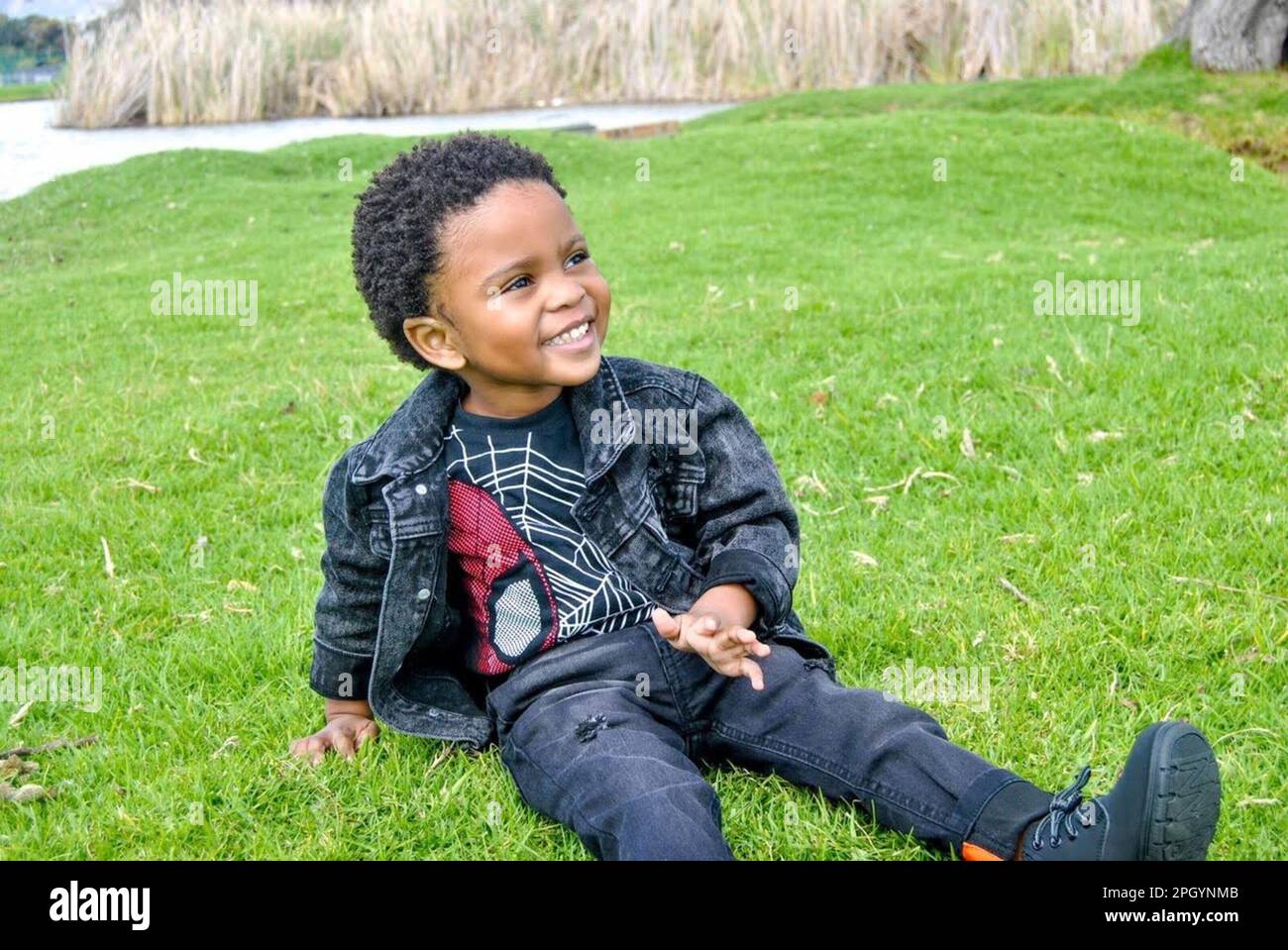 black cute boy child looking up smiling Stock Photo - Alamy