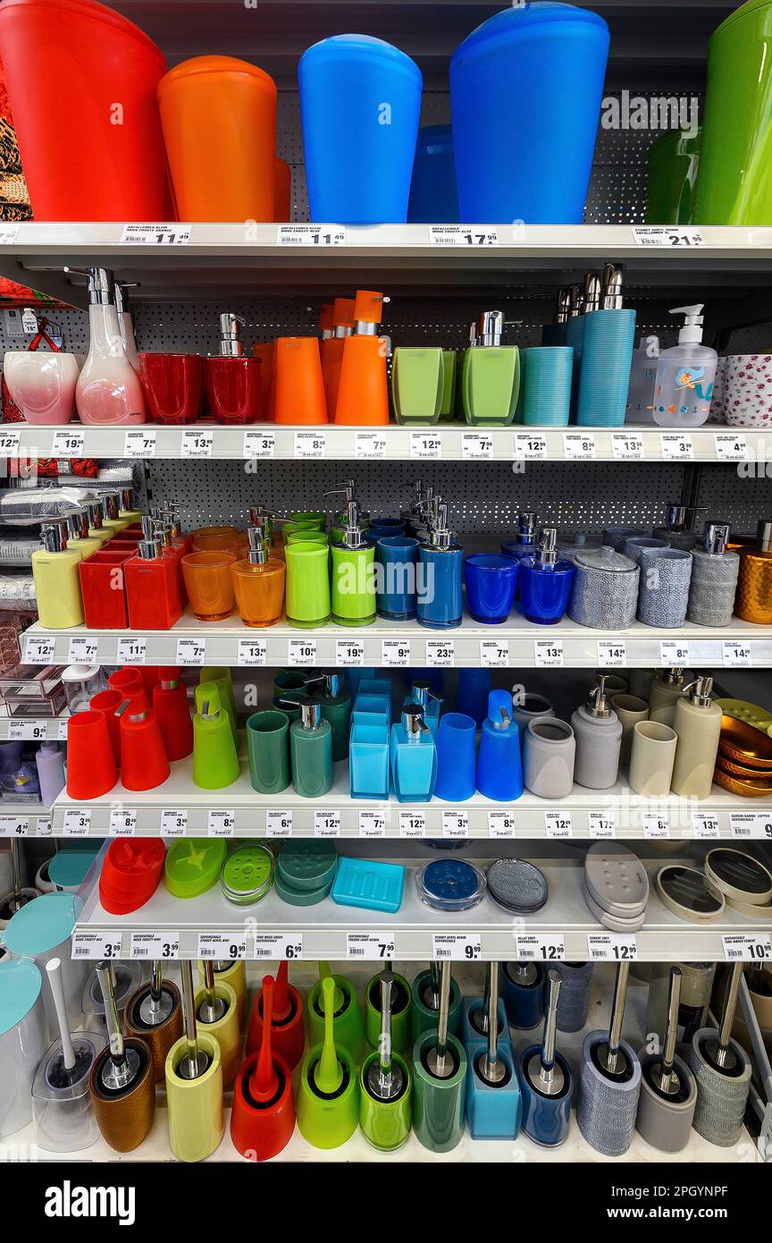 Shelf with colourful soap dispensers and toilet brushes in a DIY store ...