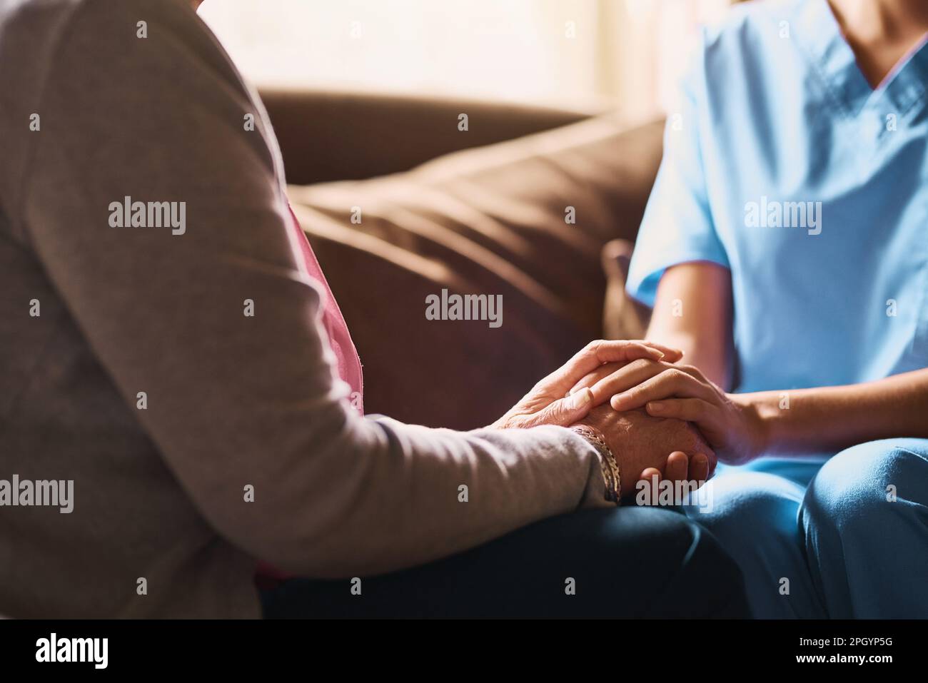 It takes a special person with just the right touch. a nurse holding a senior womans hands in ...