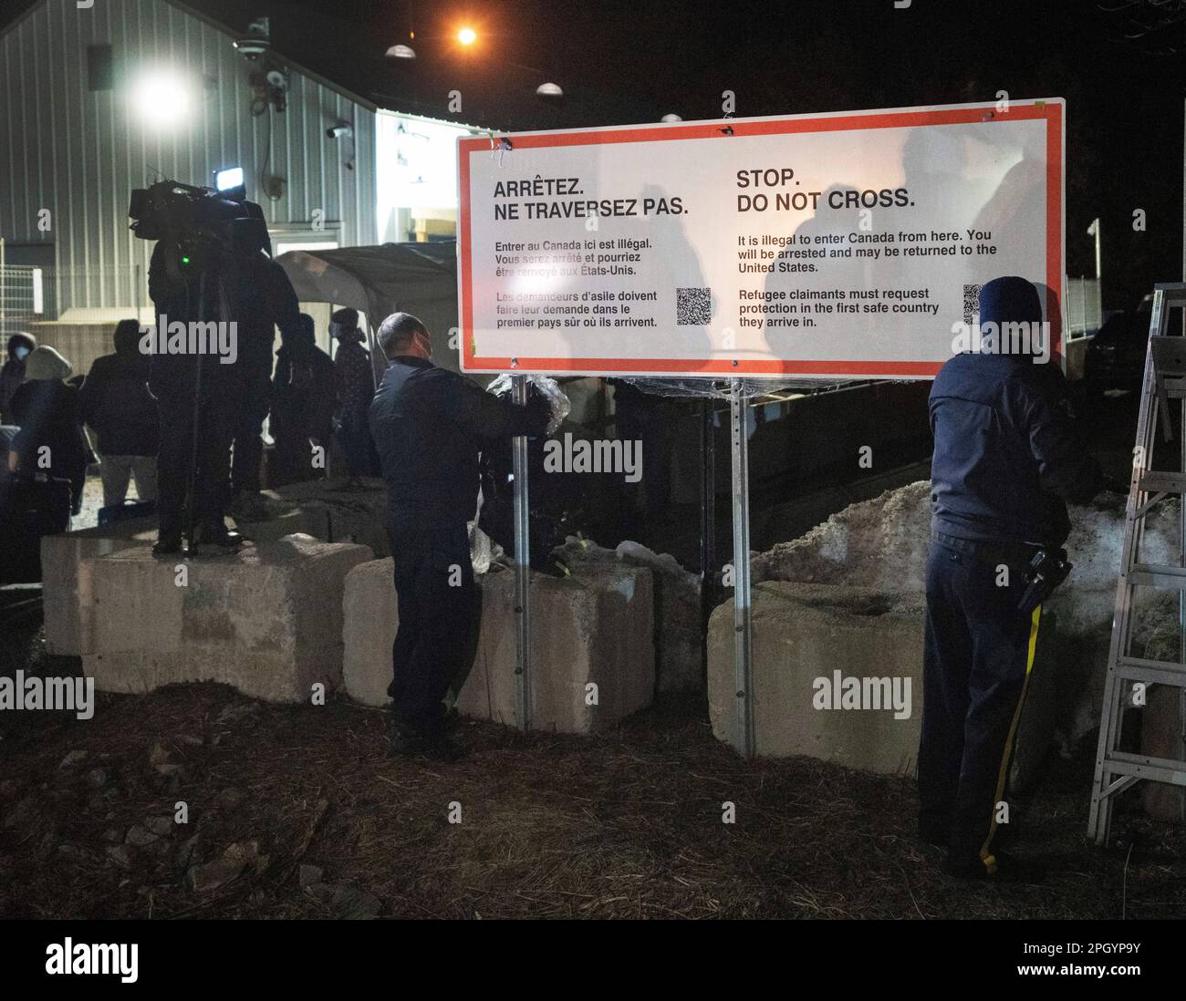 Royal Canadian Mounted Police officers unwrap a new warning sign for ...
