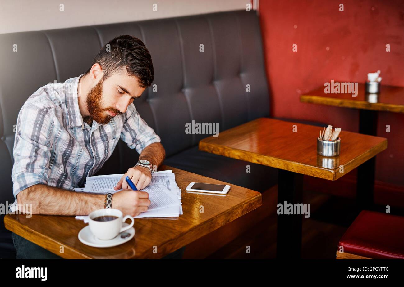 Going over the number for the month. a shop owner doing paperwork in ...