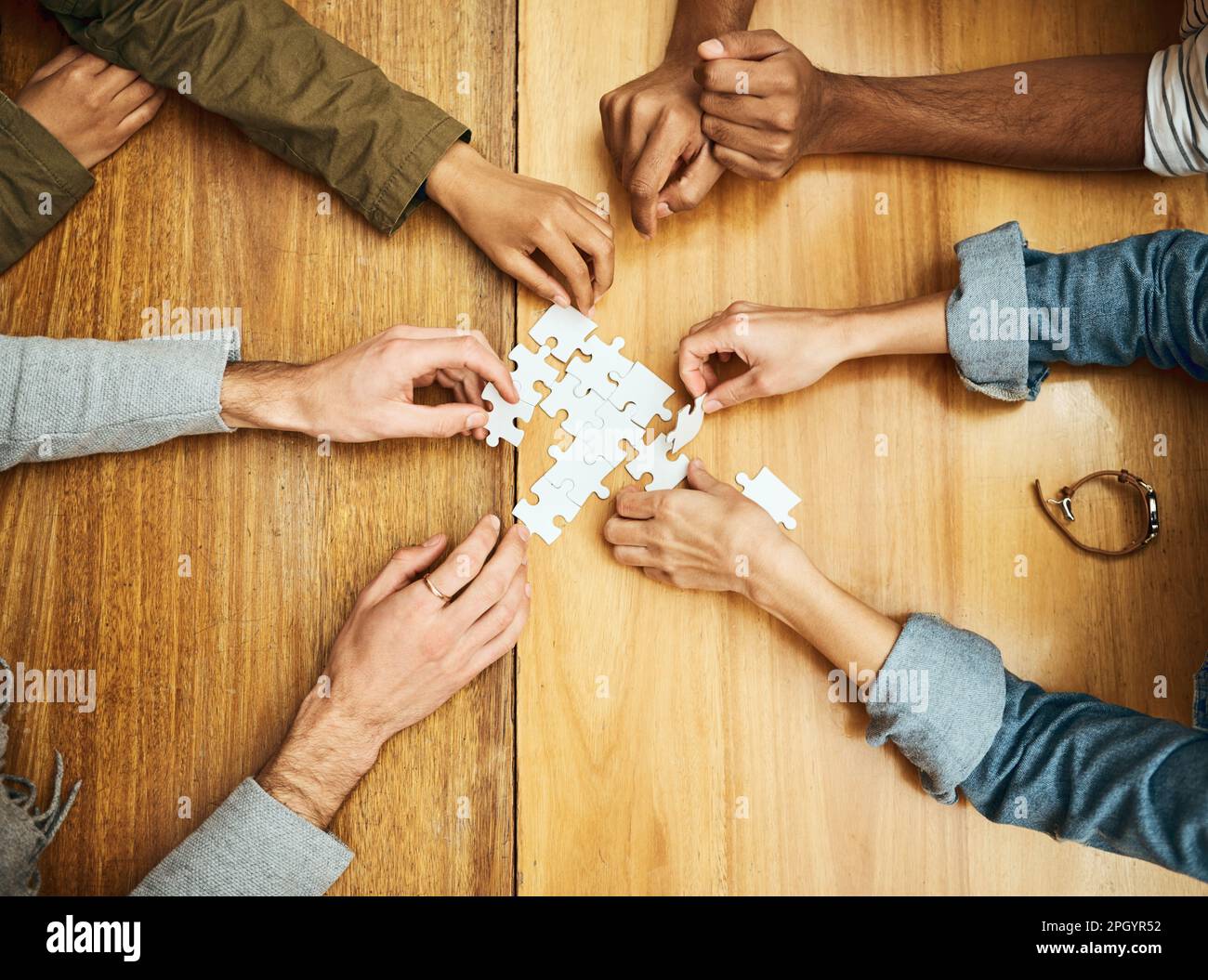 Every piece is important. High angle shot of a group of unrecognizable ...