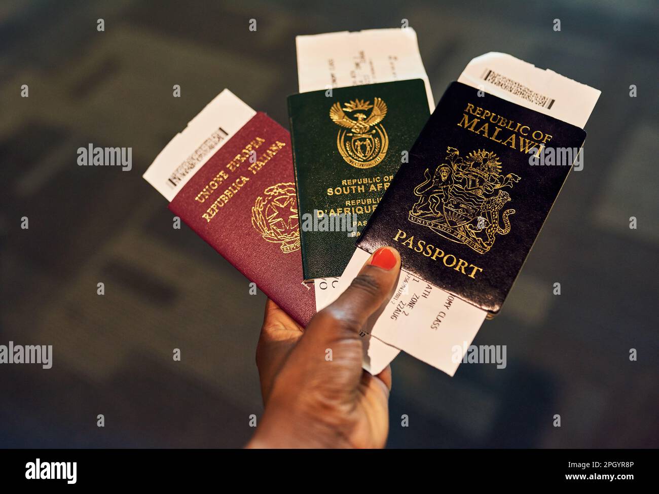 Hands holding passports hi-res stock photography and images - Alamy