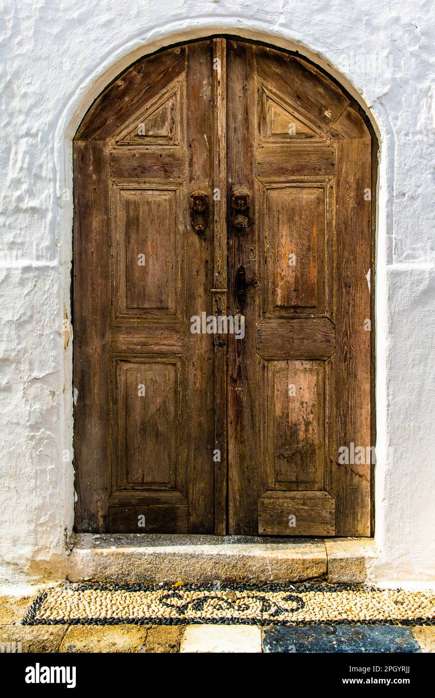 Old wooden doors with pebble mosaics on the floor, winding streets with ...