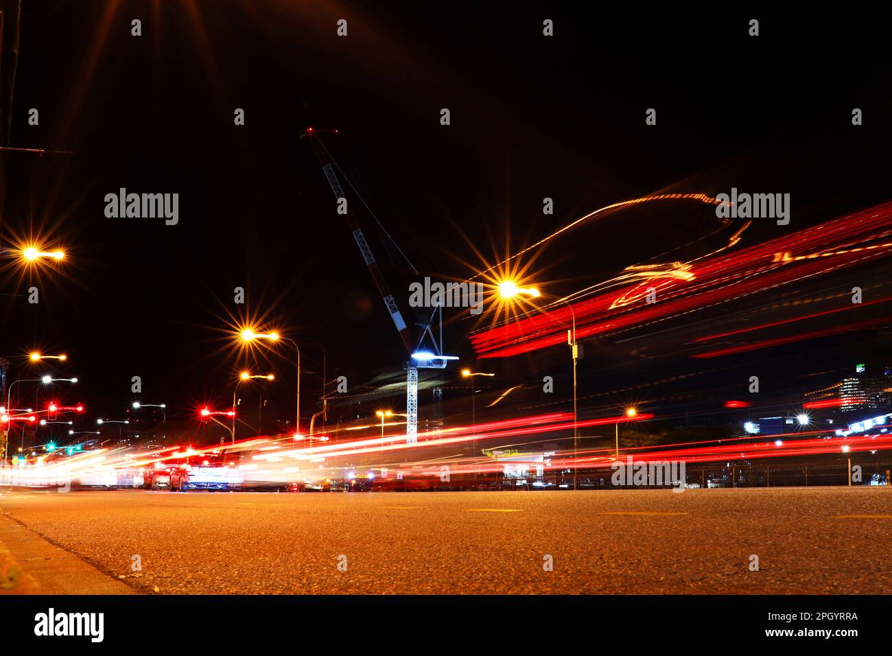 Light trails from fast cars on a night out in the city outside a ...