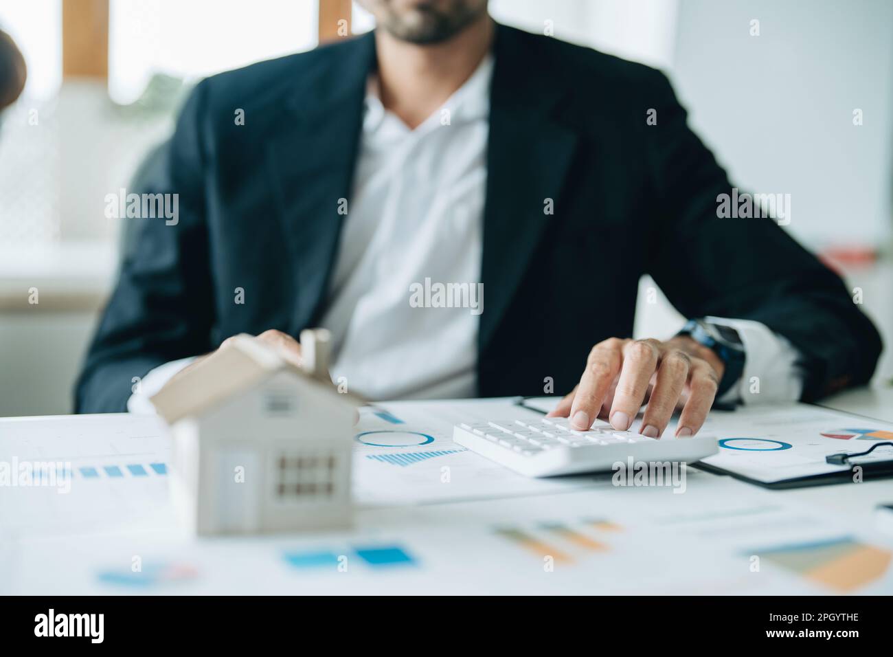 Bank loan workers are using calculators to calculate home loan interest ...