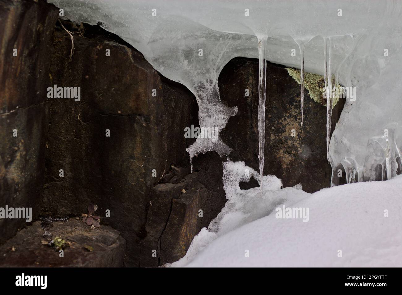 Ice covered black rocks hi-res stock photography and images - Alamy