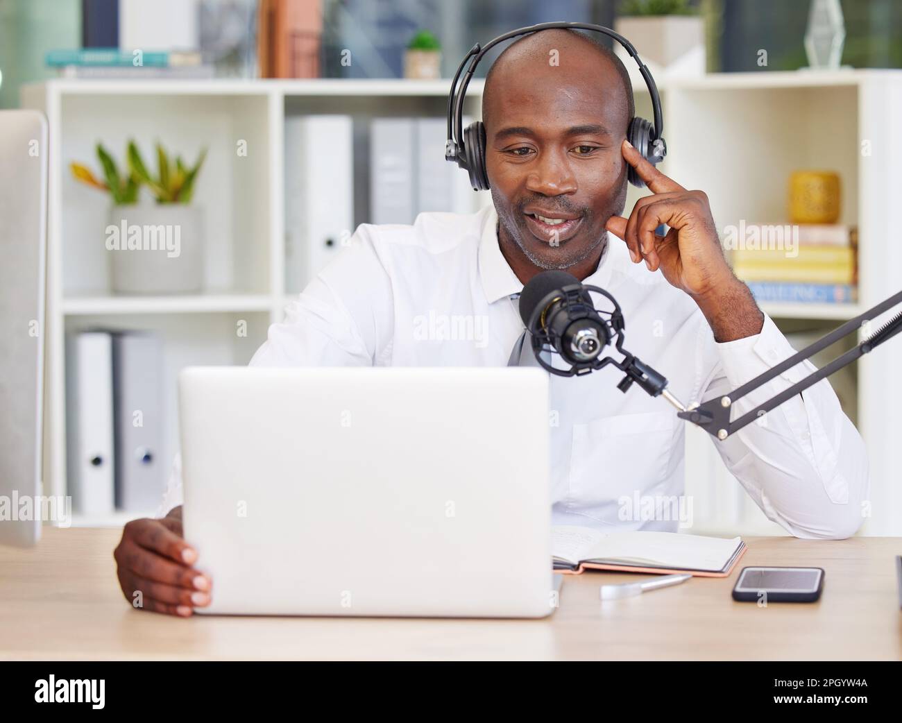 African man reading into microphone hi-res stock photography and images ...