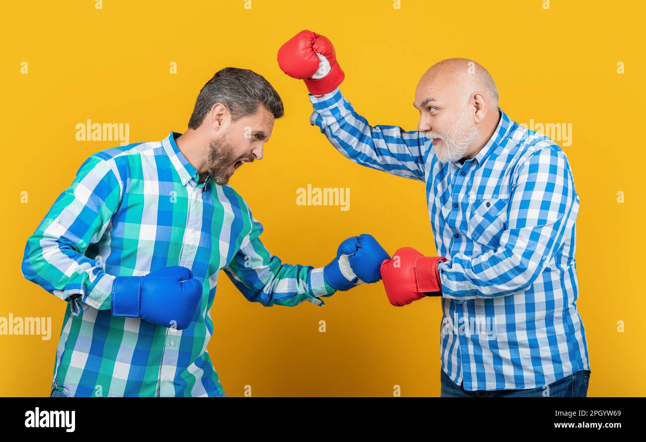 angry two generation men fighting isolated on yellow. generation men ...