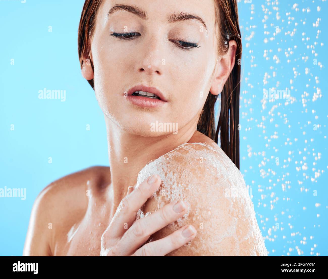 Shower soap, woman and body cleaning in a studio with a female washing ...