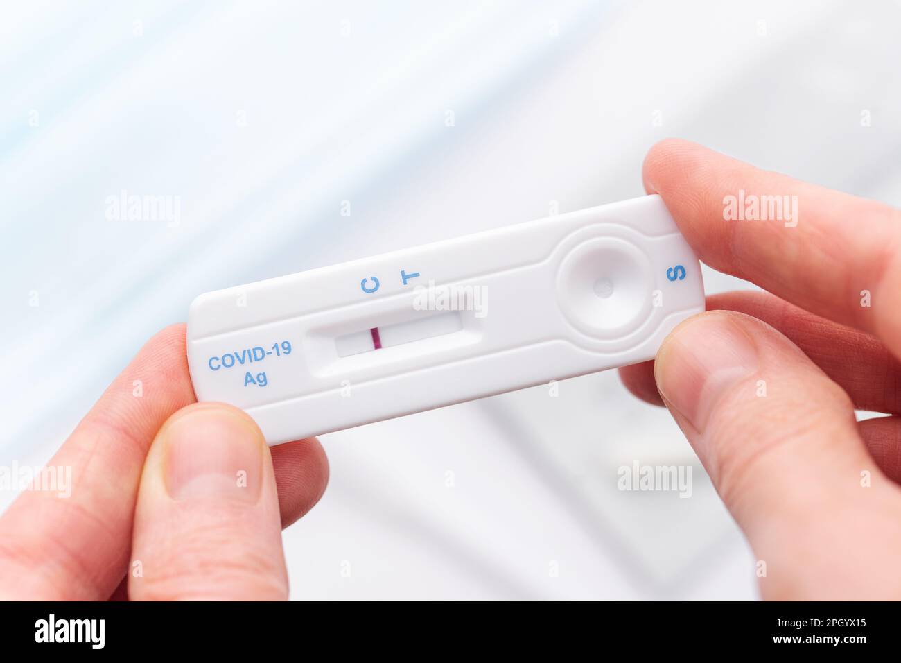 Hand holding a negative result for COVID-19 with test kit for viral ...