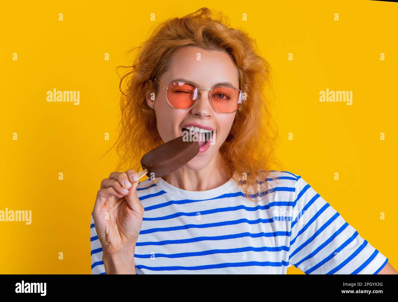 girl eating icelolly ice cream on background. photo of girl with ...