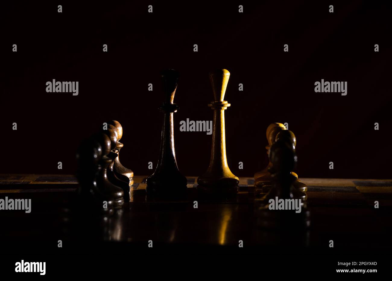 chess pieces in the dark playing chess Stock Photo - Alamy