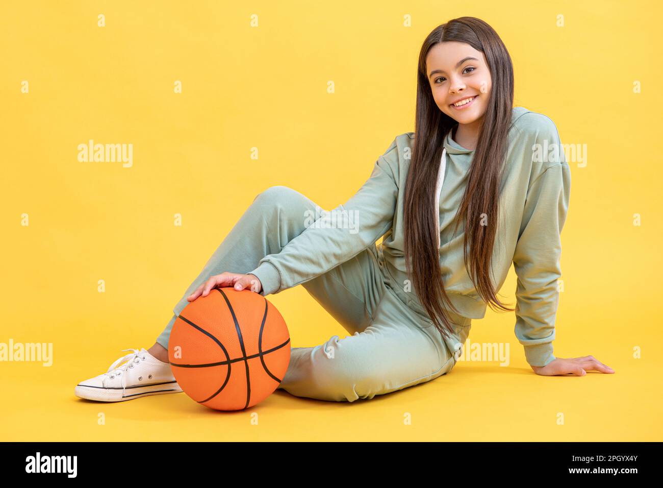 Girl sitting on basketball hi-res stock photography and images - Alamy