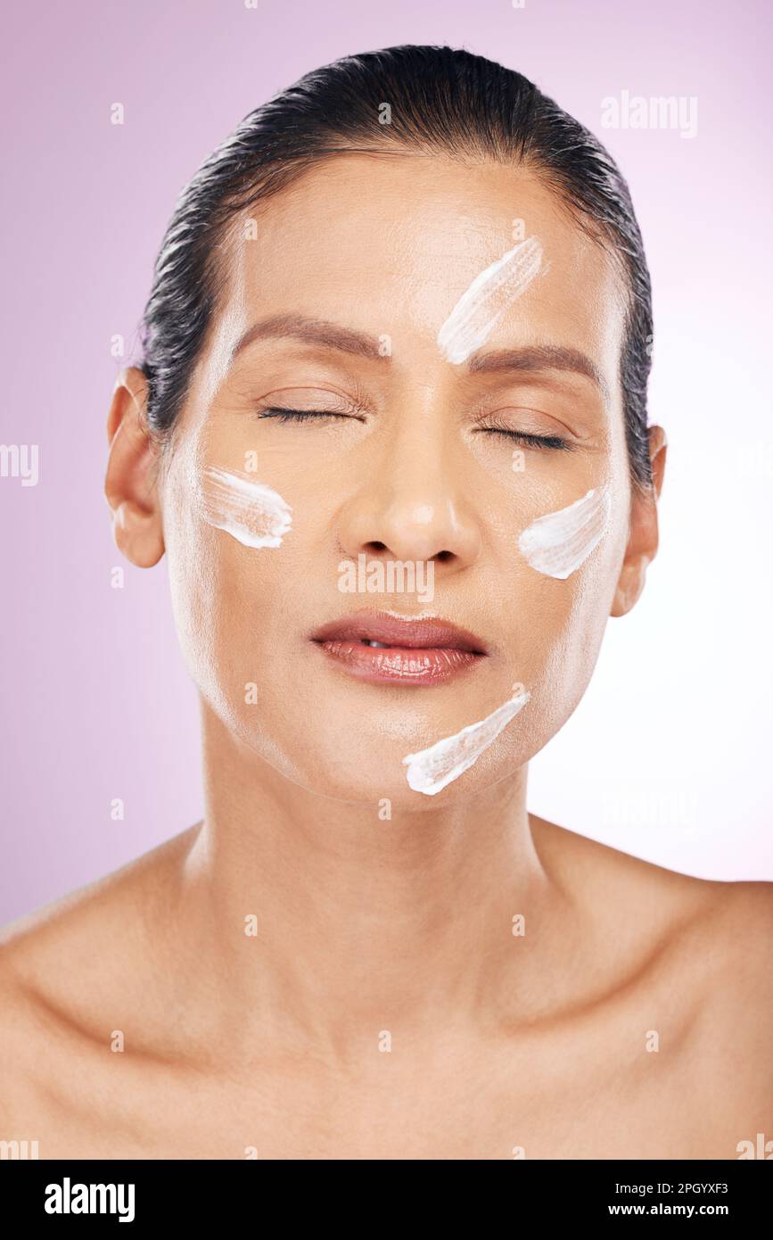 Face, cream and skincare of woman with eyes closed in studio isolated ...