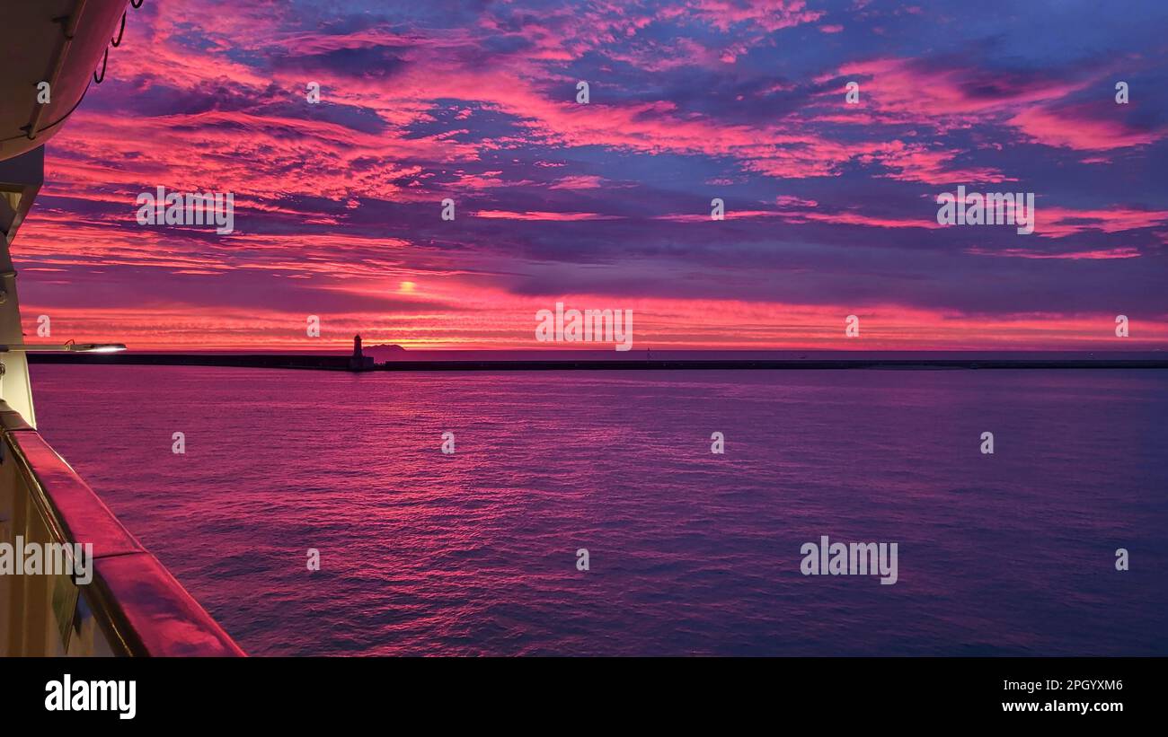 A stunning sunset sky is seen from the deck of a cruise ship ...