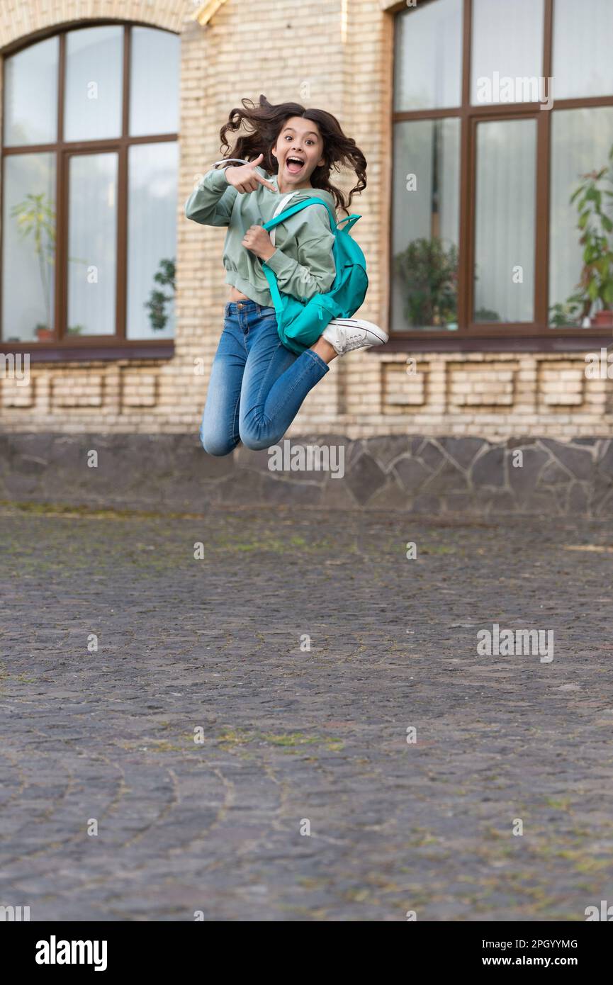 school girl jump childhood at the street, back to school. photo of ...