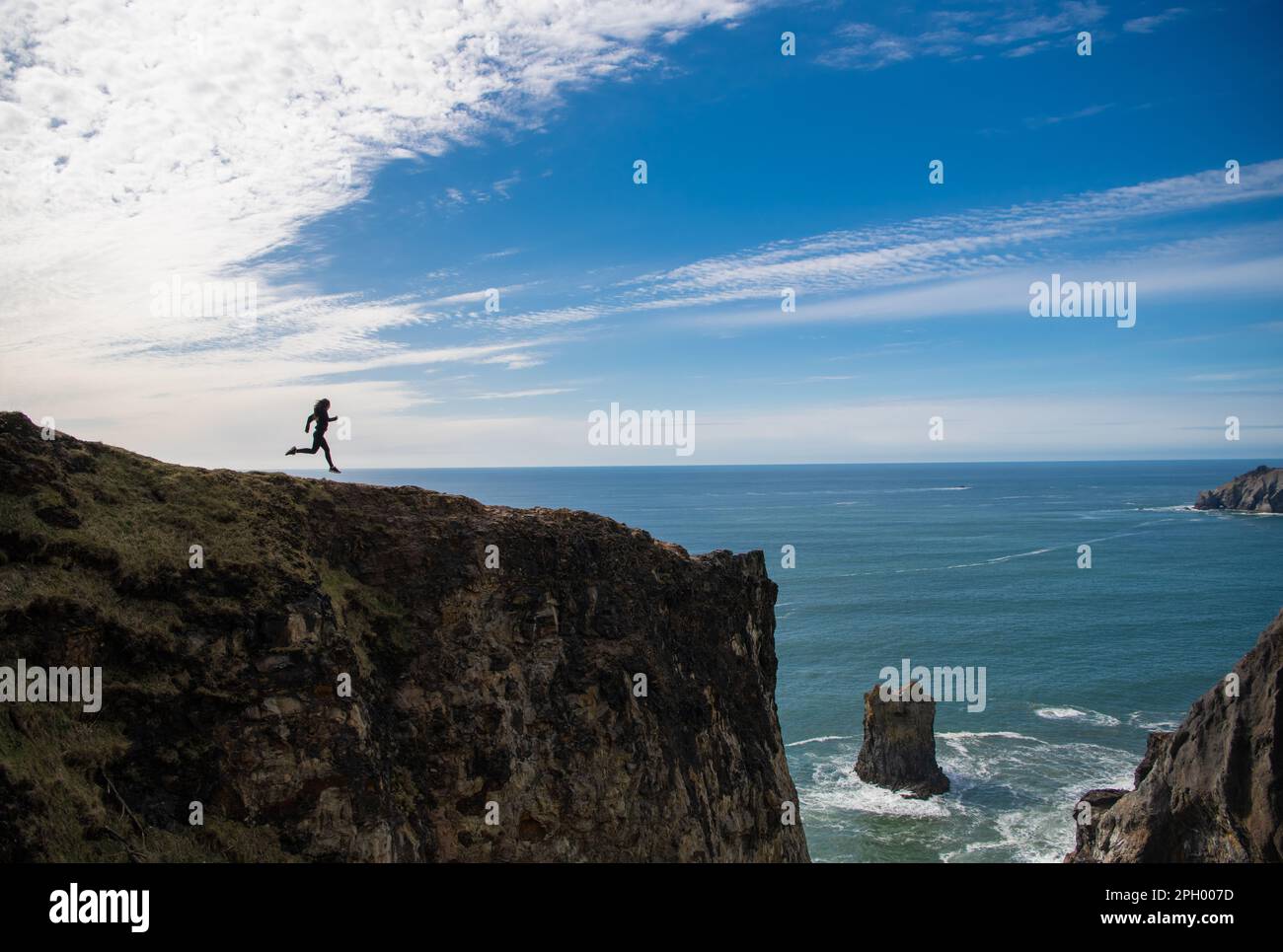 free woman runner running on the cliff. freedom and motivation Stock ...