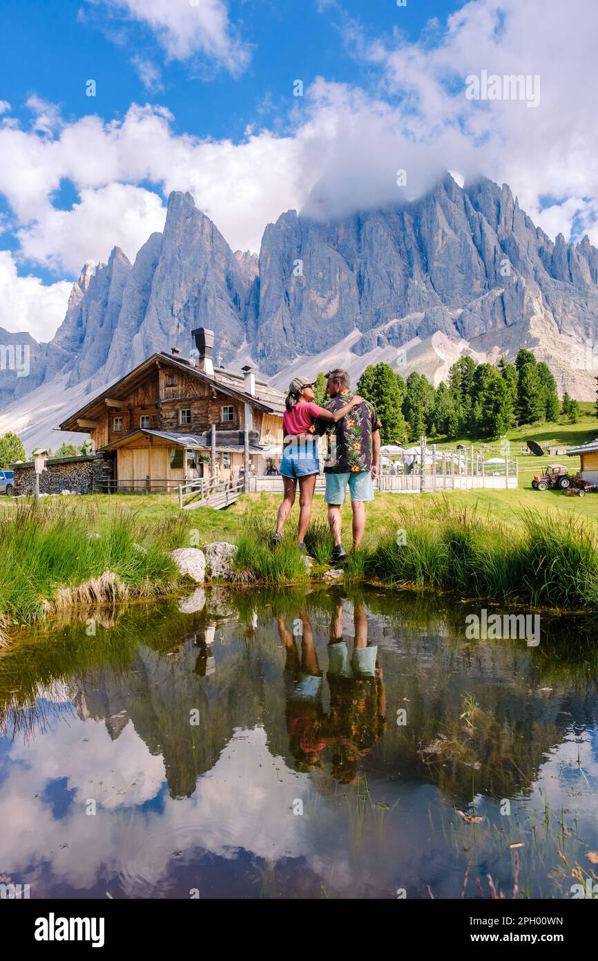 Couple men and women at Geisler Alm, Dolomites Italy, hiking in the ...