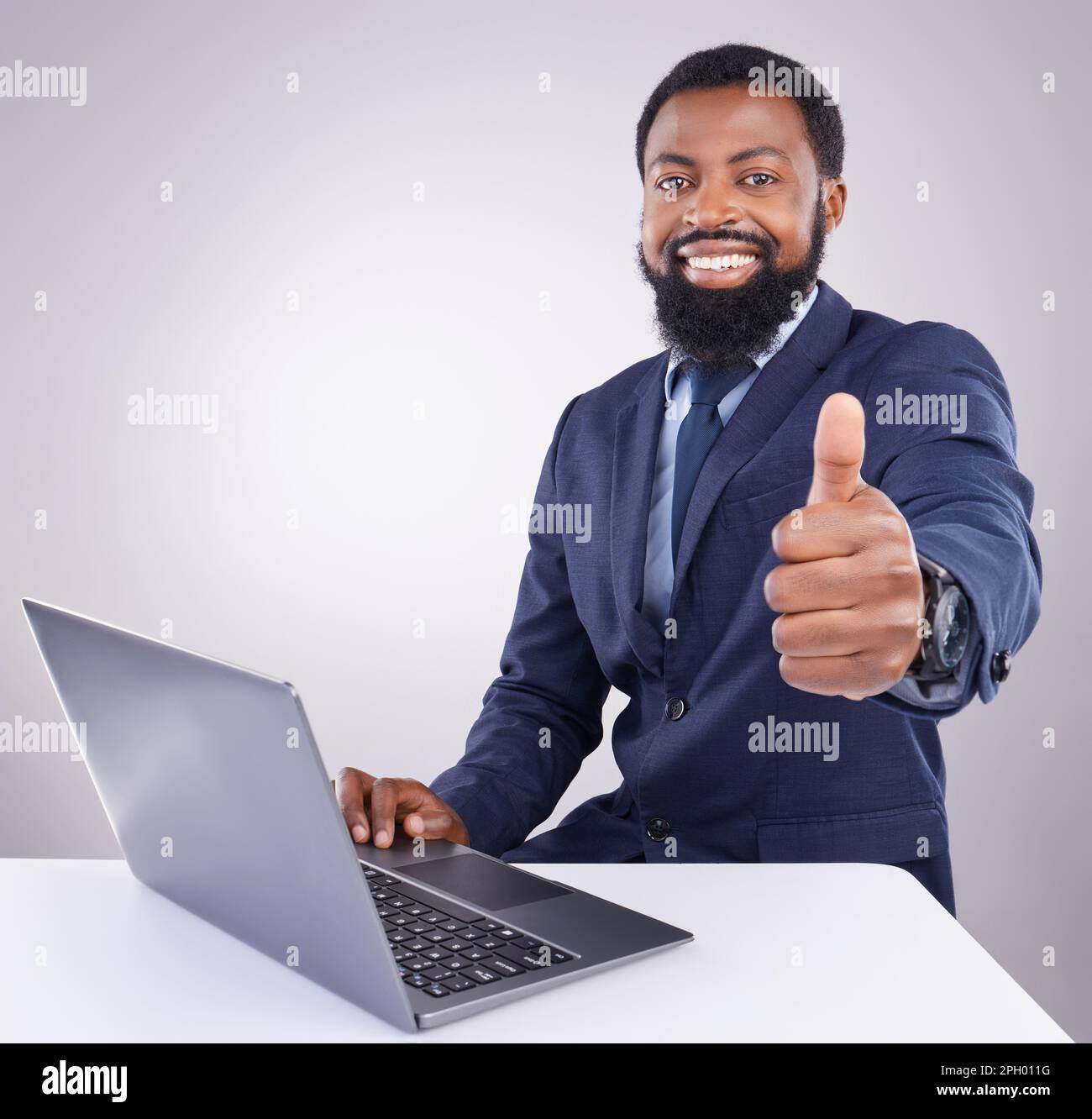 Black man, laptop and thumbs up isolated on a white background portrait ...