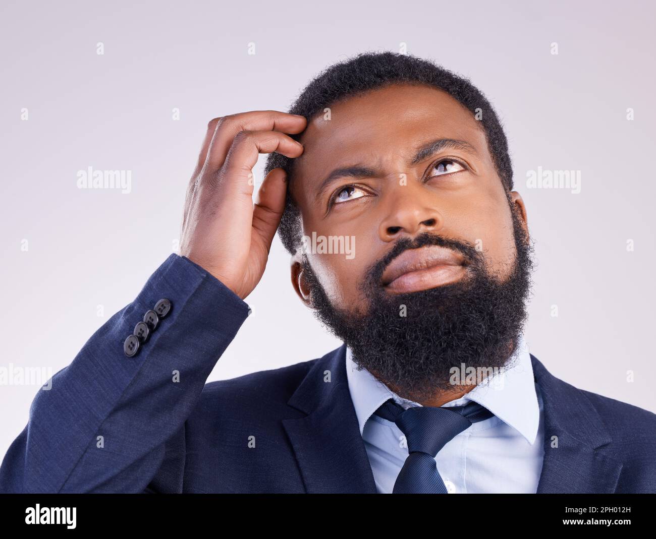 Confused business man thinking in studio of ideas, doubt and remember ...