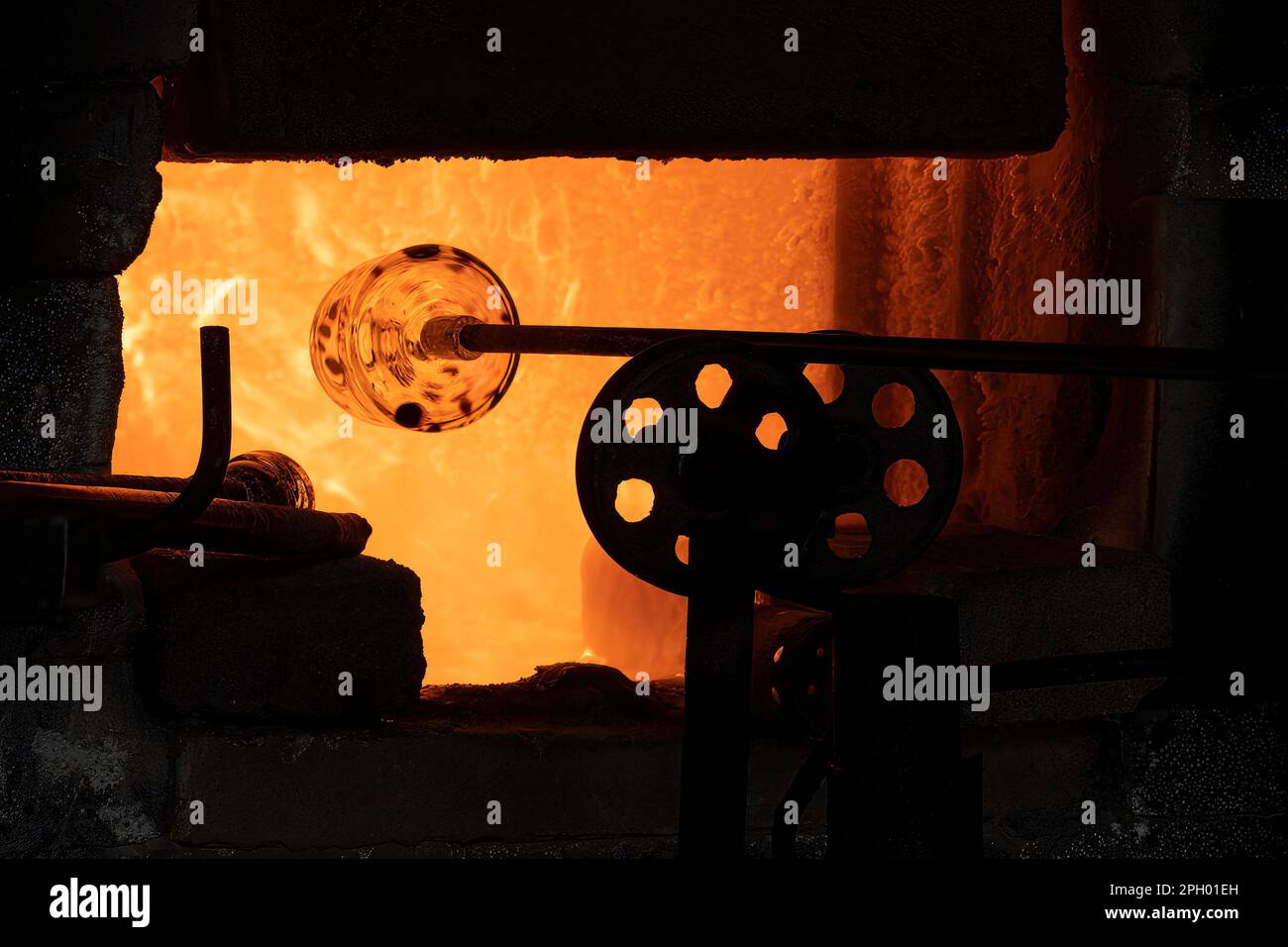 A glass bottle heated in a glass melting furnace, so it can be ...