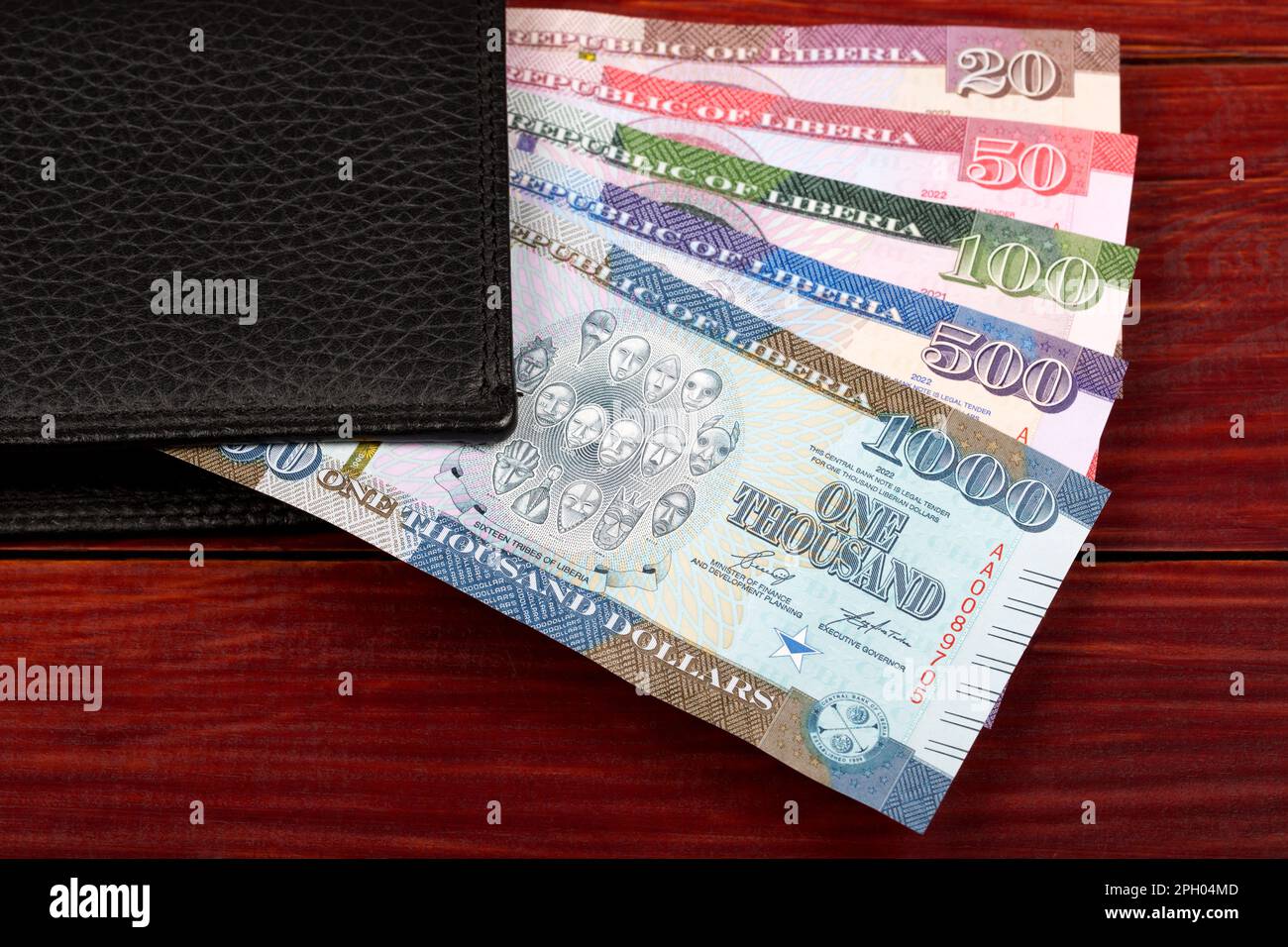 Liberian money - dollar - new series of banknotes in the black wallet ...