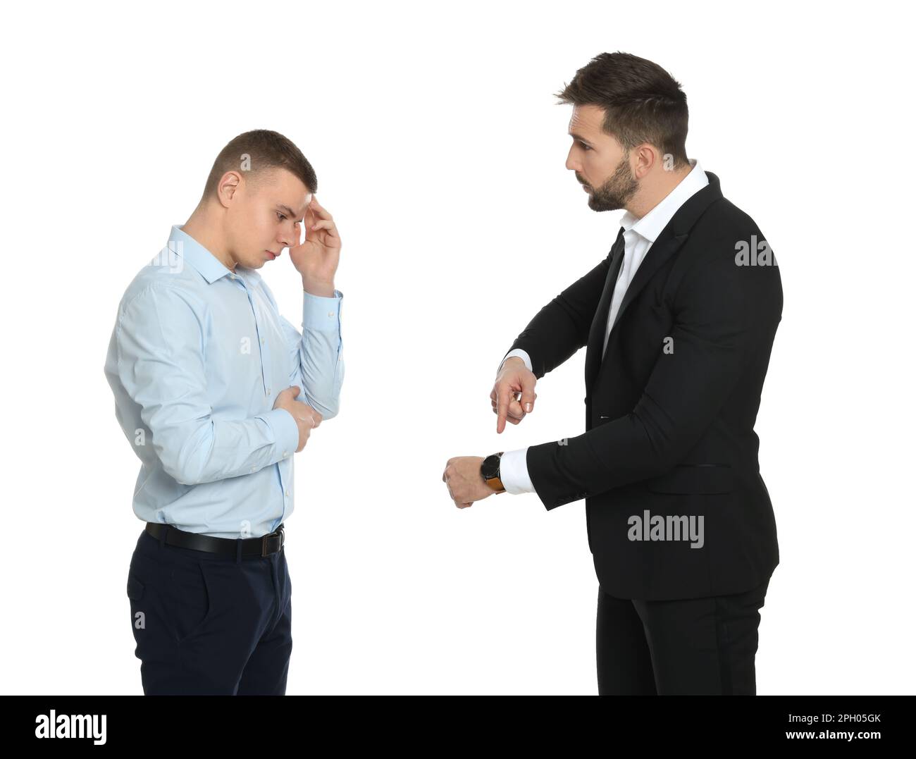 Businessman pointing on wrist watch while scolding employee for being ...