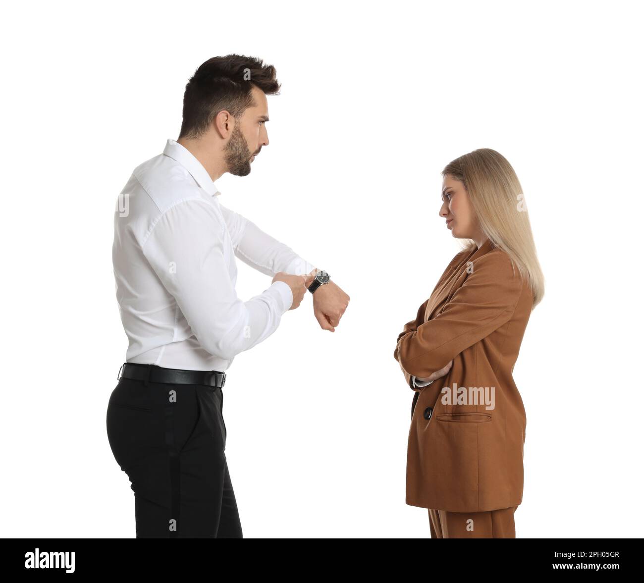 Businessman pointing on wrist watch while scolding employee for being ...
