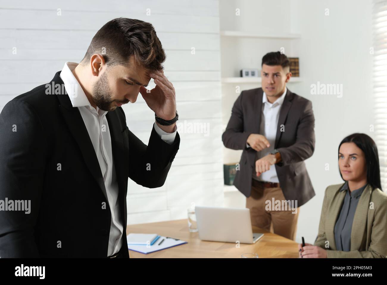 Businessman scolding employee for being late on meeting in office Stock ...
