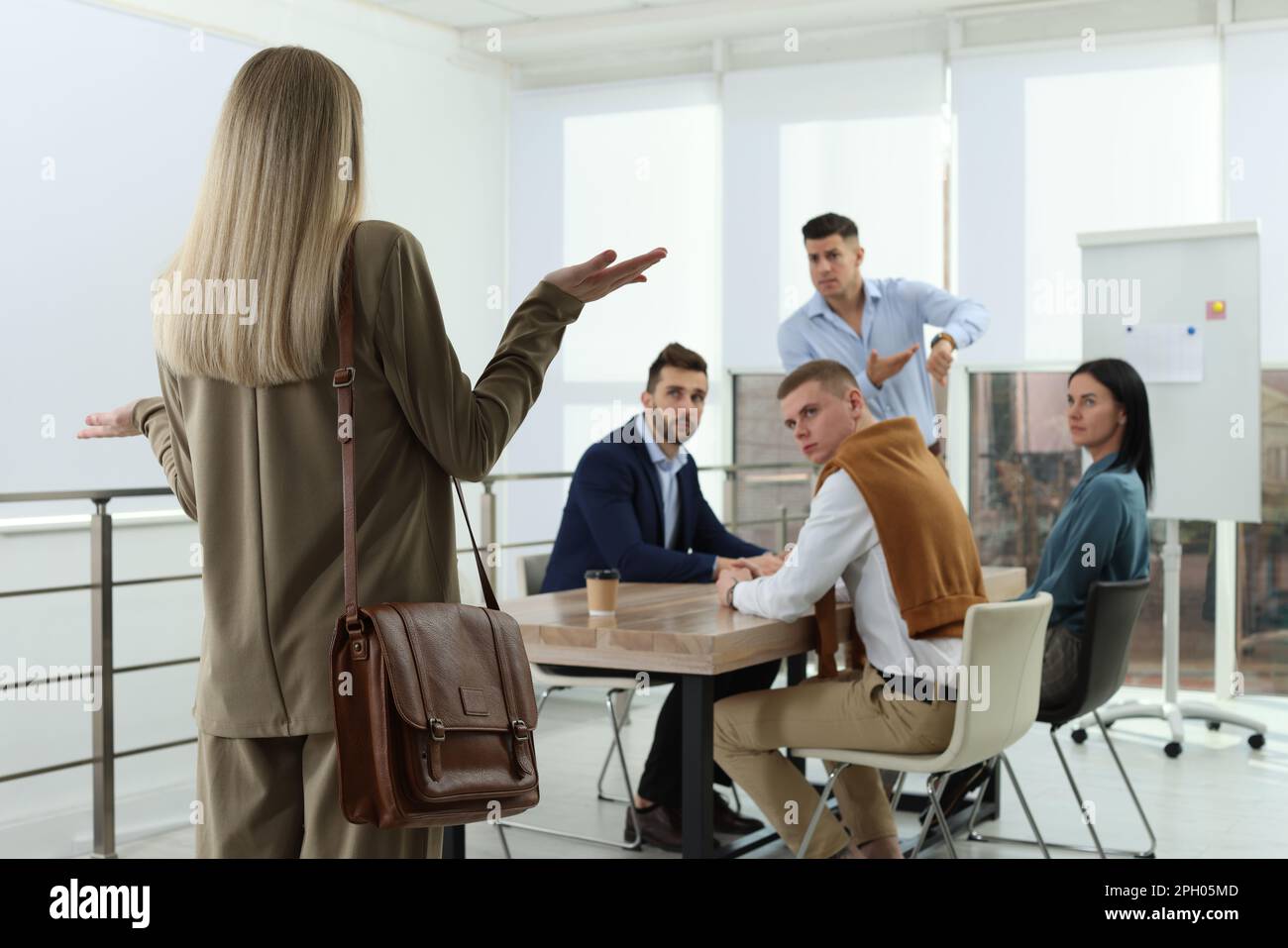 Businessman scolding employee for being late on meeting in office Stock ...