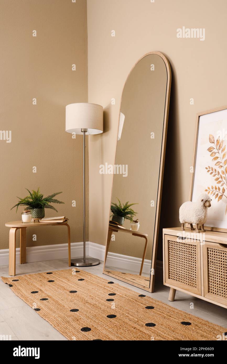 Beautiful mirror and console table near beige indoors. Interior design ...