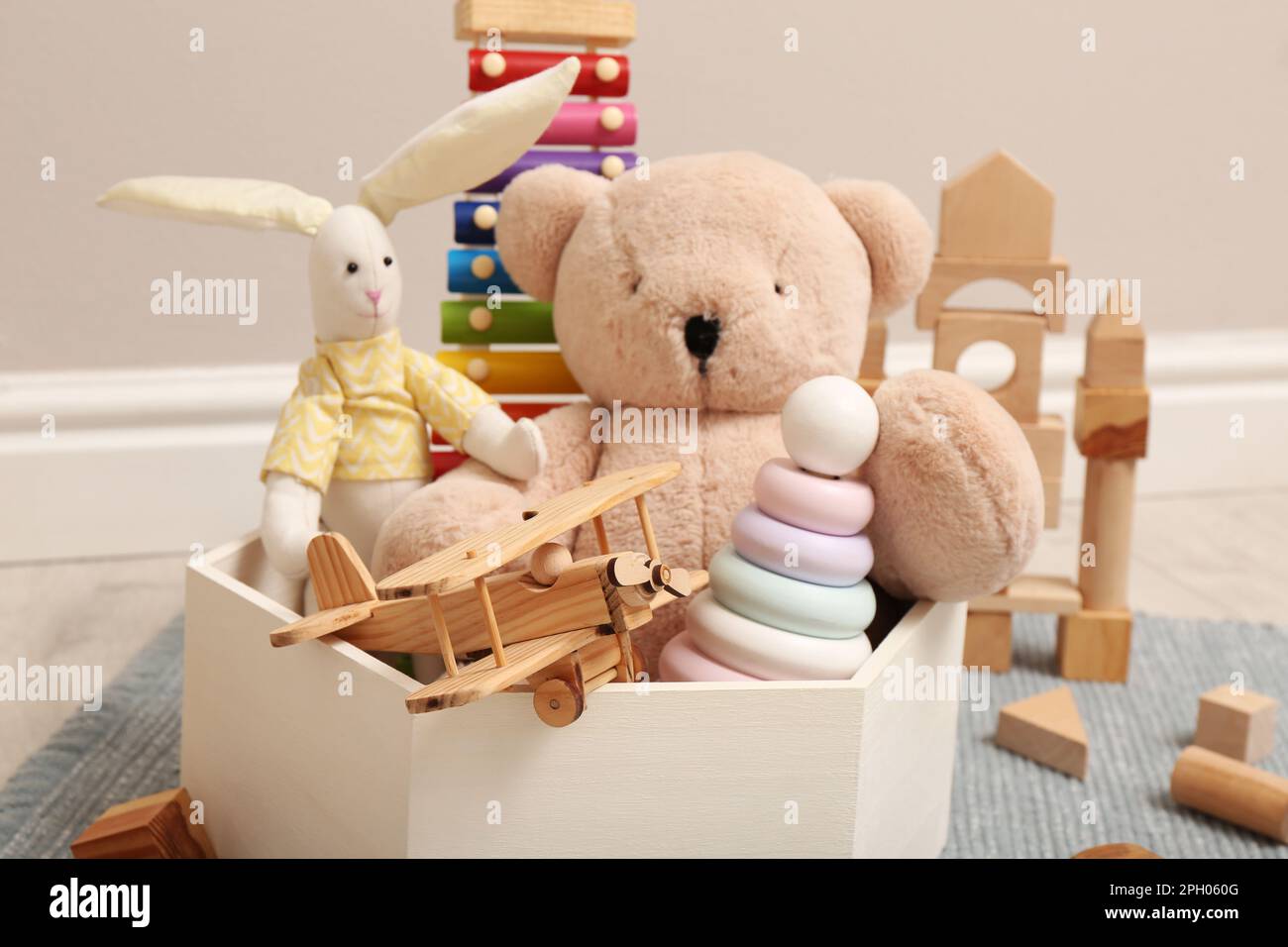 Set of different toys in box on floor, closeup Stock Photo - Alamy