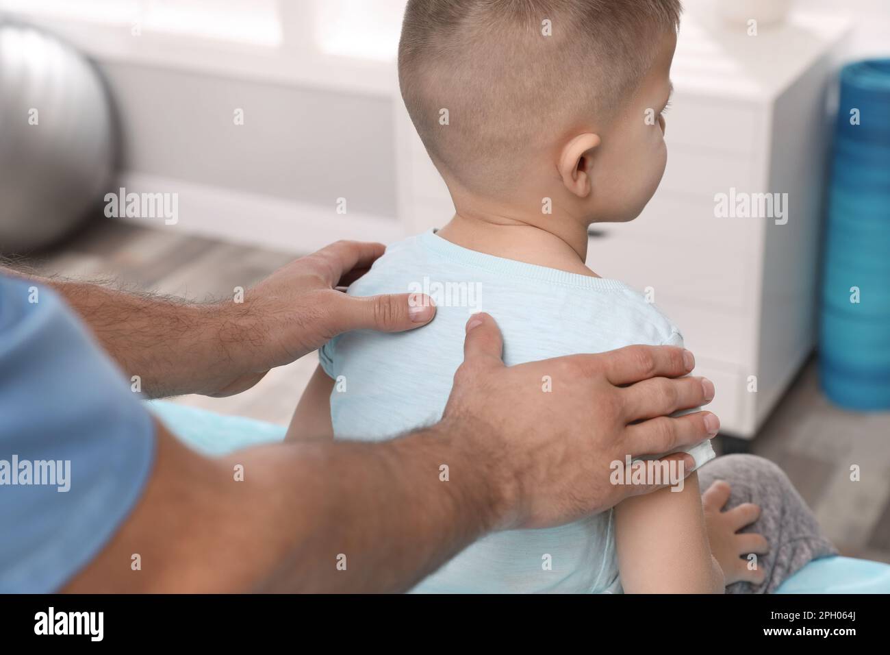 Orthopedist examining child's back in clinic, closeup. Scoliosis ...