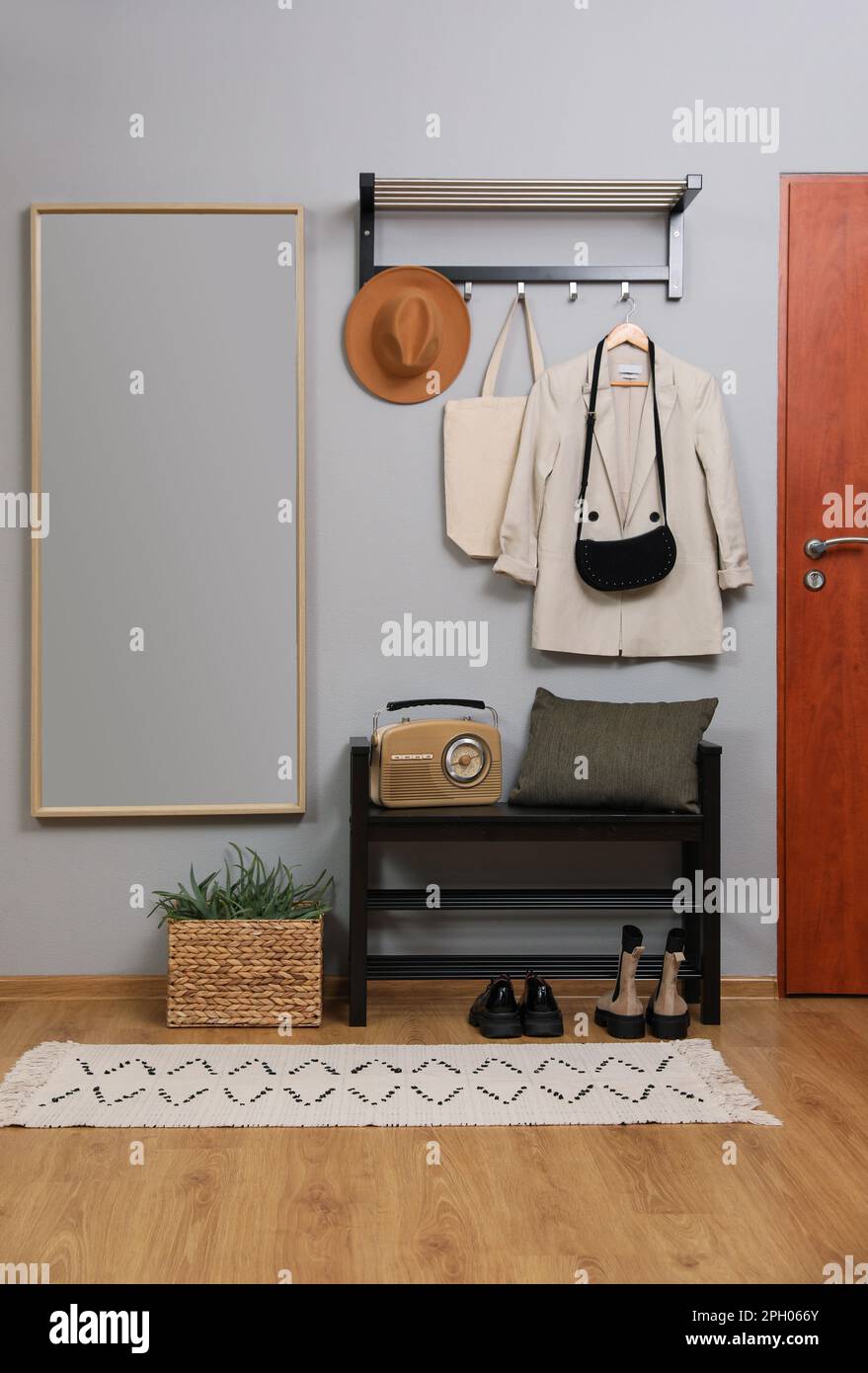 Modern hallway interior with shoe rack and mirror Stock Photo - Alamy