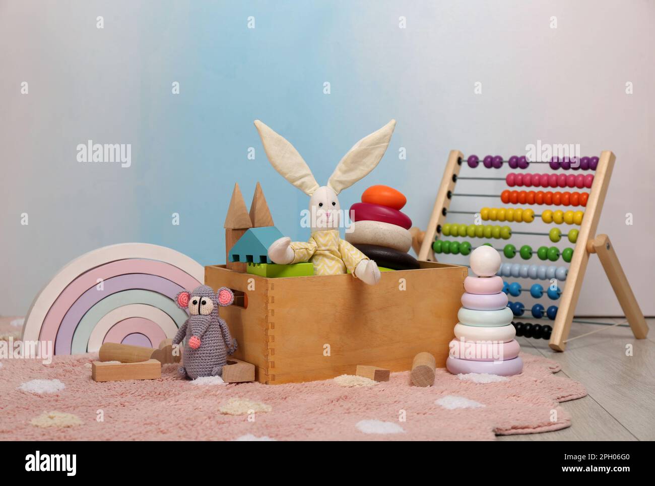 Set of different toys on rug near light wall Stock Photo - Alamy