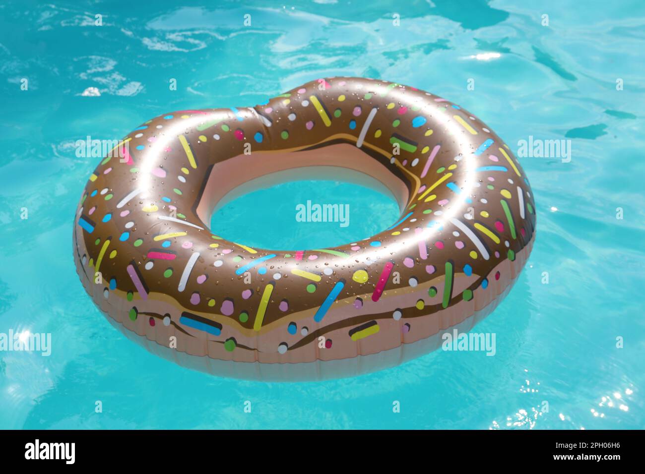 Inflatable ring floating on water in swimming pool Stock Photo - Alamy