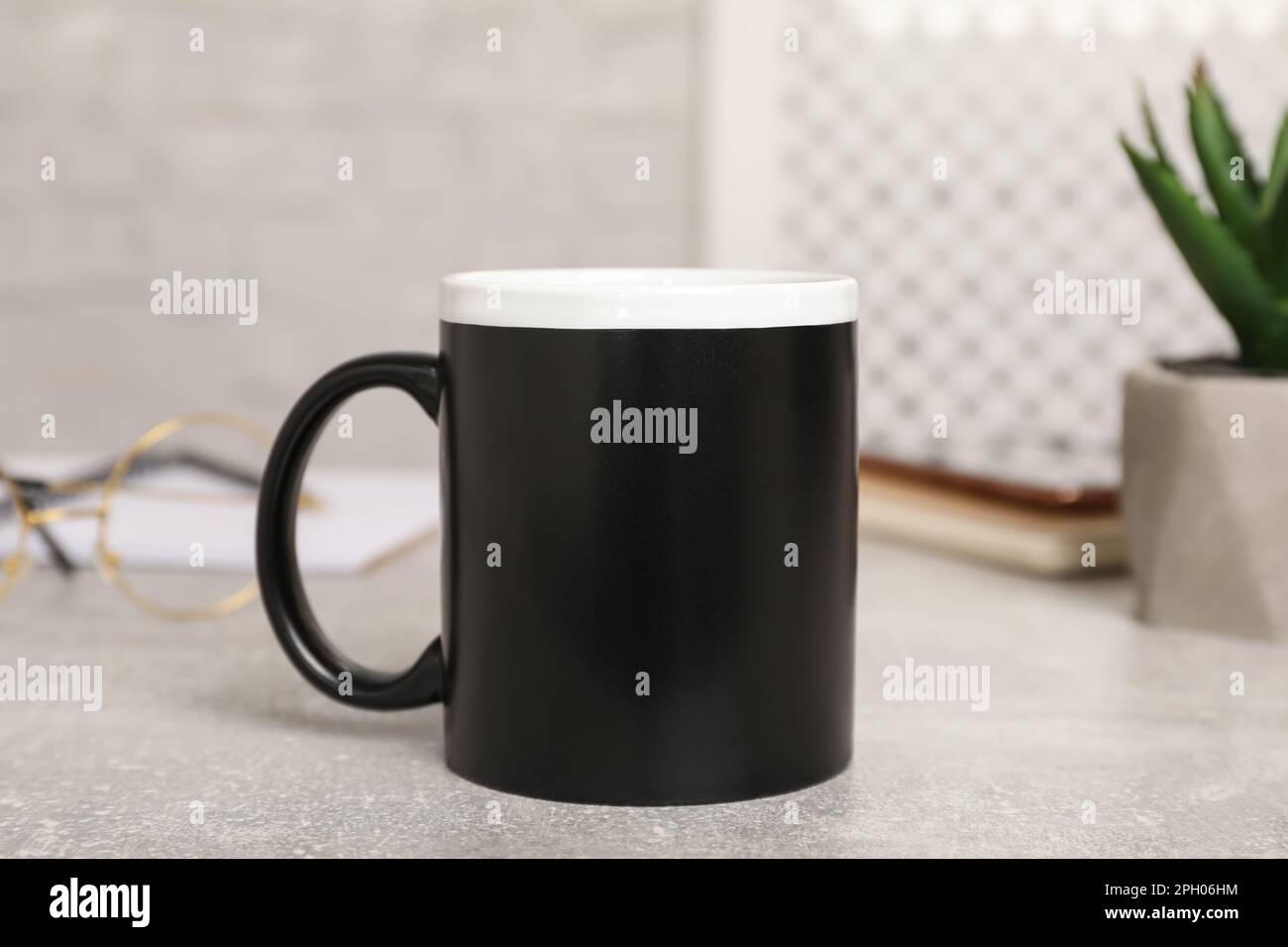 Mug of hot drink on light grey table in office. Coffee Break Stock ...