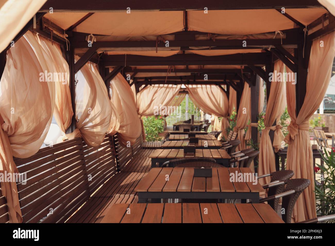 Cozy terrace of outdoor cafe with wooden furniture and beautiful ...