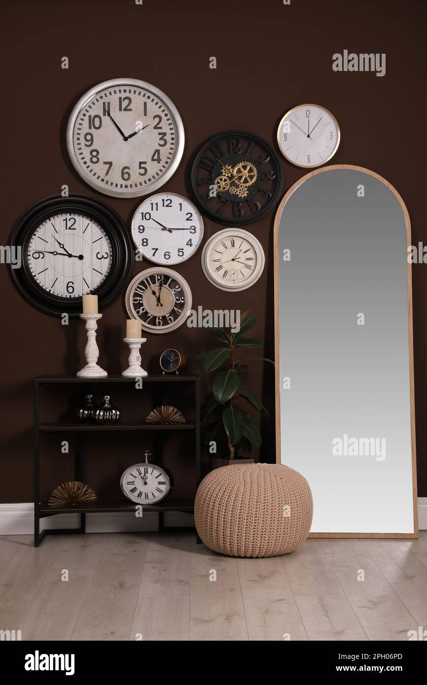 Stylish room interior with collection of wall clocks Stock Photo - Alamy