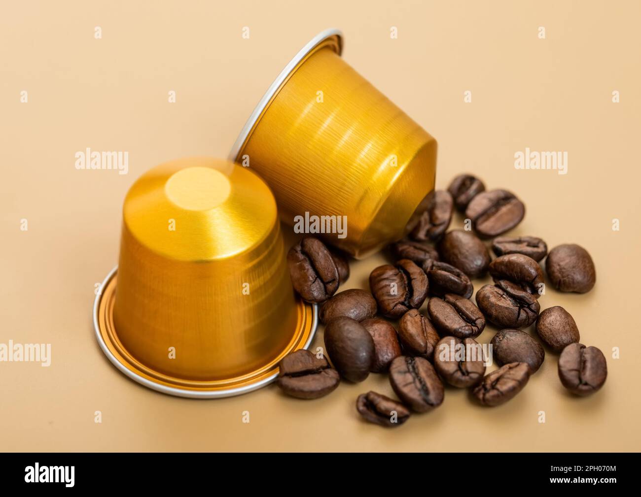 Coffee capsules with fresh raw aroma beans on beige background.Macro ...