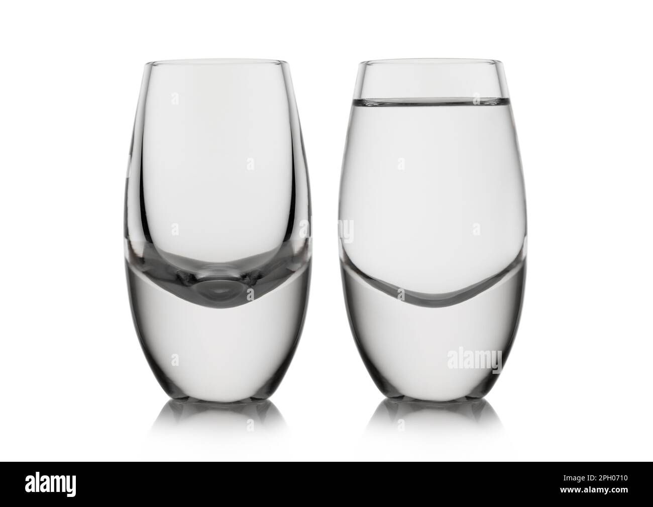 Shot glass with tequila or cold clear vodka alcohol drink on white ...