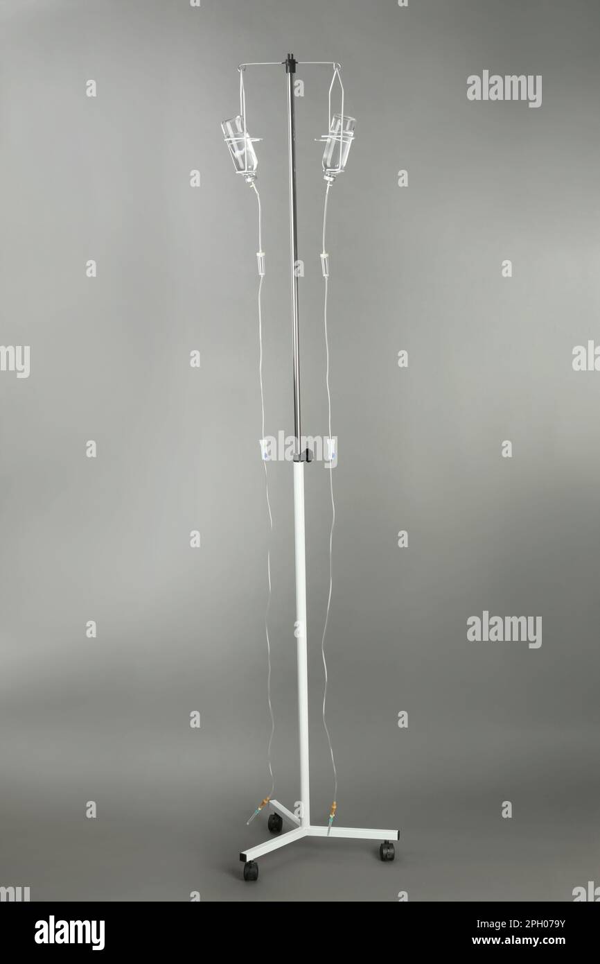 Drop counter with bottles of medicine on grey background Stock Photo ...