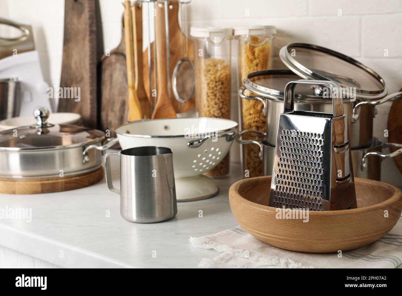 Different cooking utensils and raw pasta on countertop in kitchen Stock ...